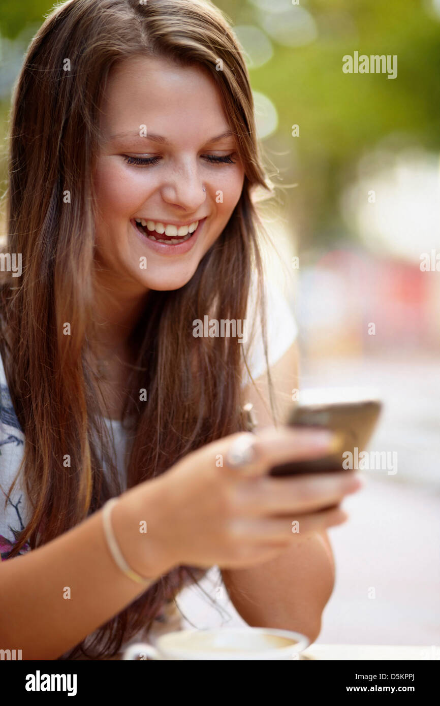 Young woman using mobile phone Stock Photo - Alamy