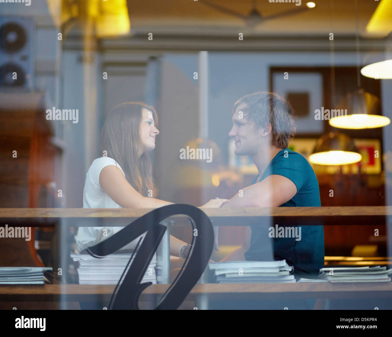 Portrait of couple talking in coffee shop Stock Photo - Alamy