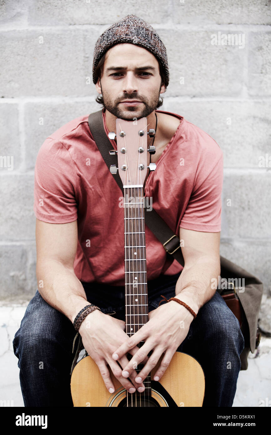 Portrait of musician against brick wall Stock Photo - Alamy