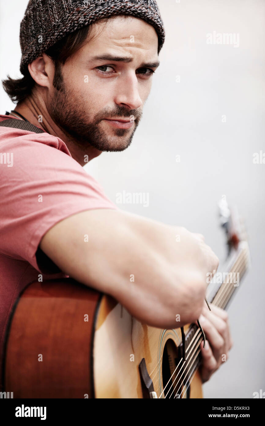 Portrait of musician playing guitar outdoors Stock Photo - Alamy