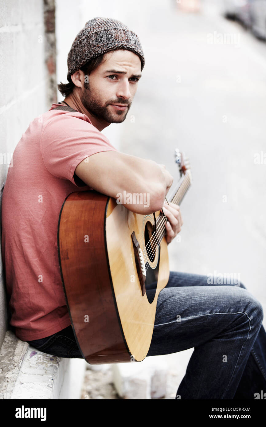 Portrait of musician playing guitar outdoors Stock Photo - Alamy