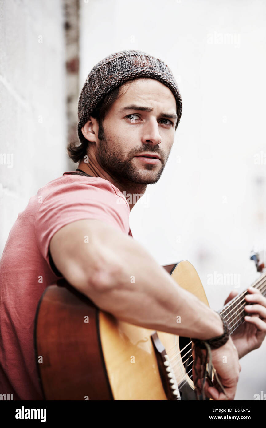Portrait of musician playing guitar outdoors Stock Photo - Alamy