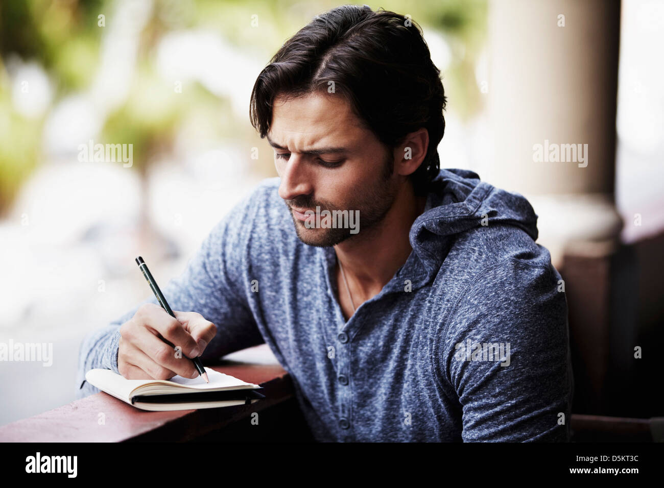 Man writing diary Stock Photo - Alamy
