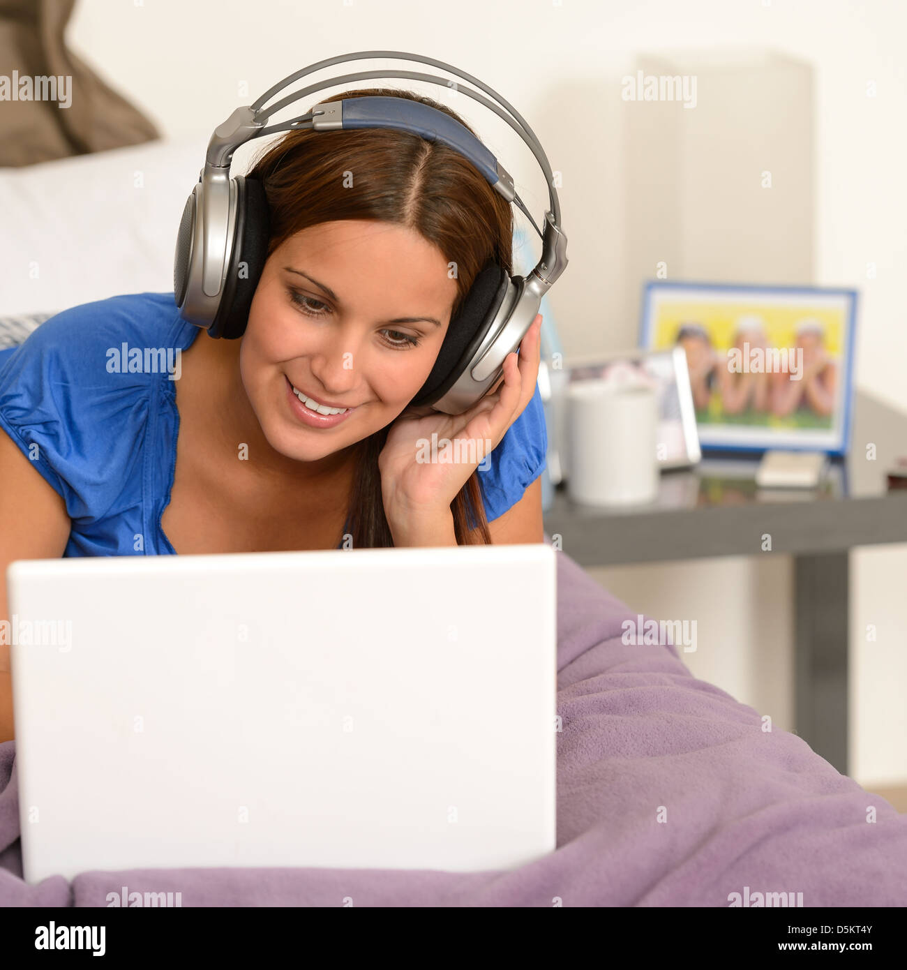 Teenage girl surfing on internet with laptop and headphones Stock Photo ...
