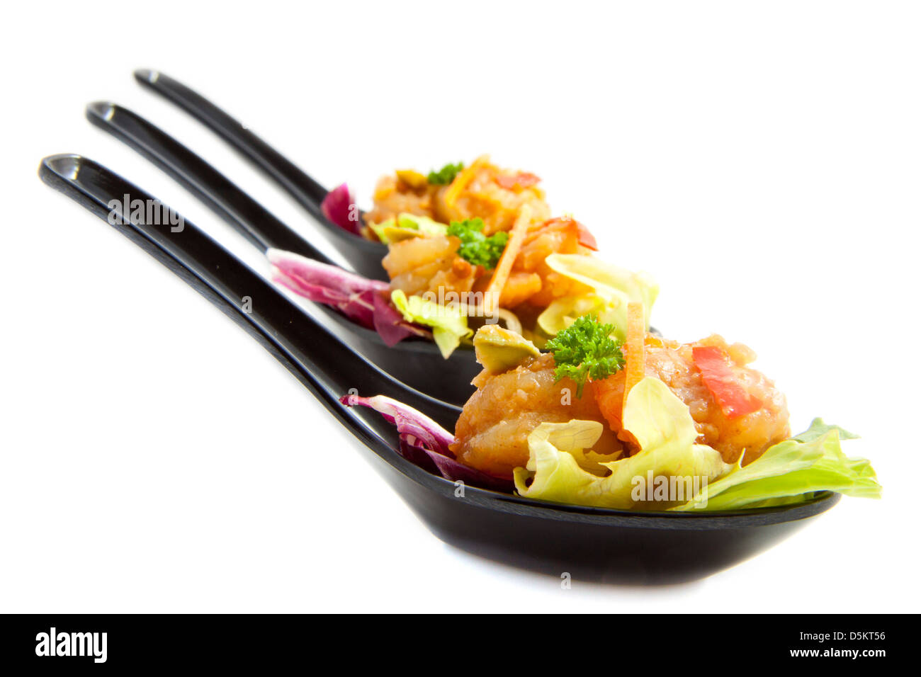 Black spoons filled with nice food isolated over white Stock Photo - Alamy