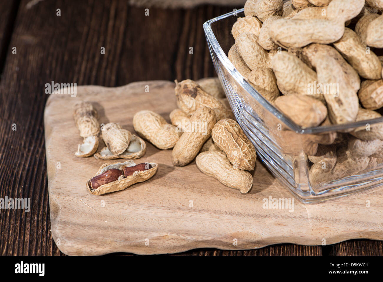 Heap of Peanuts on rustic wooden background Stock Photo - Alamy