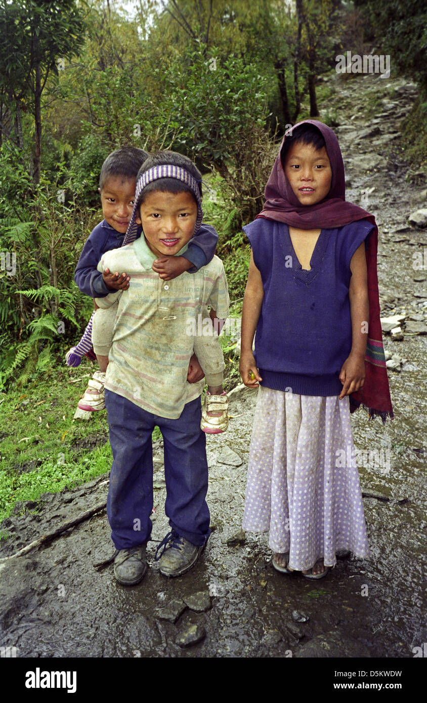 Three cute Nepalese children on Annapurna circuit track near Sikha ...