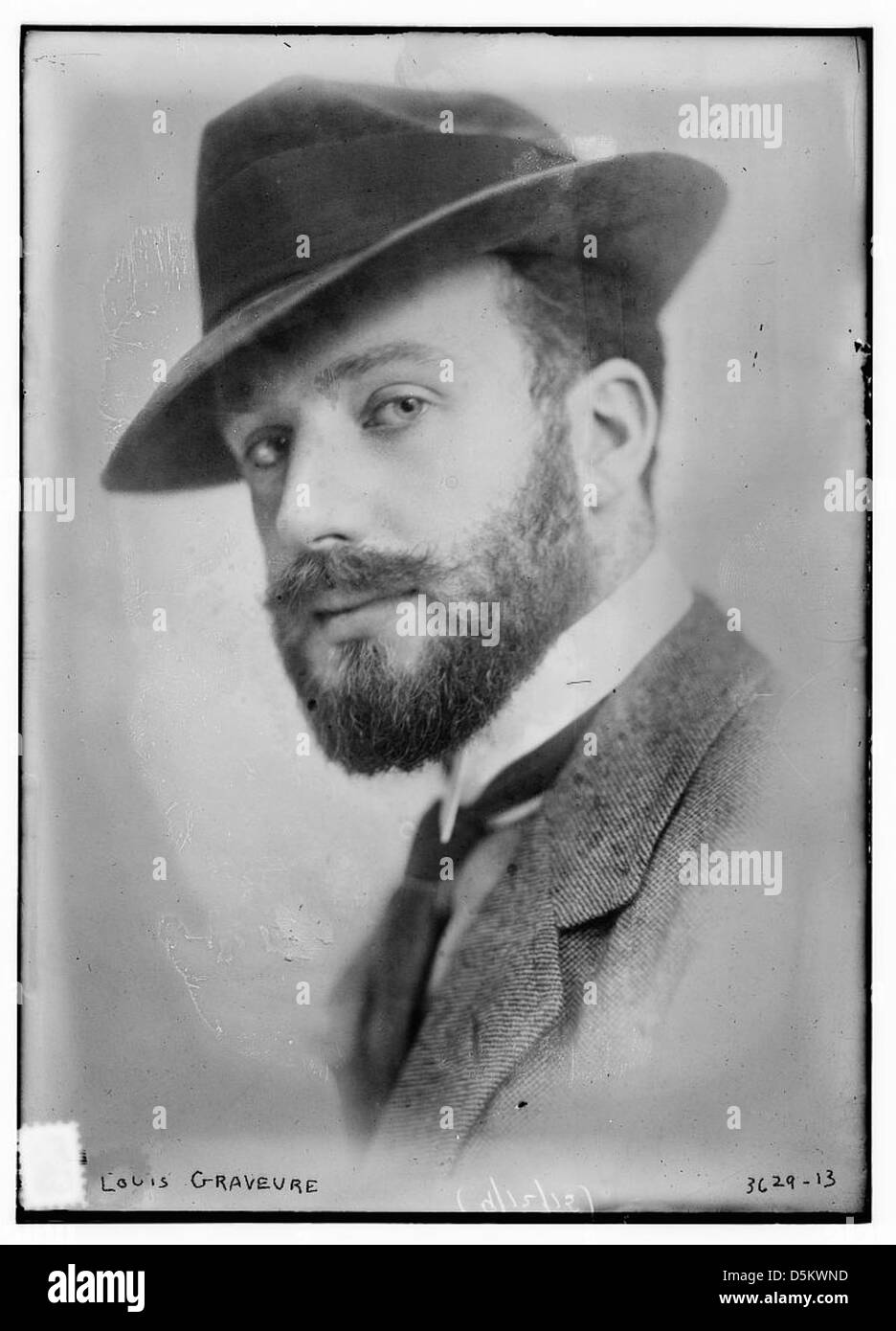 A portrait of Louis Graveure, depicting a man with a beard. He is shown ...