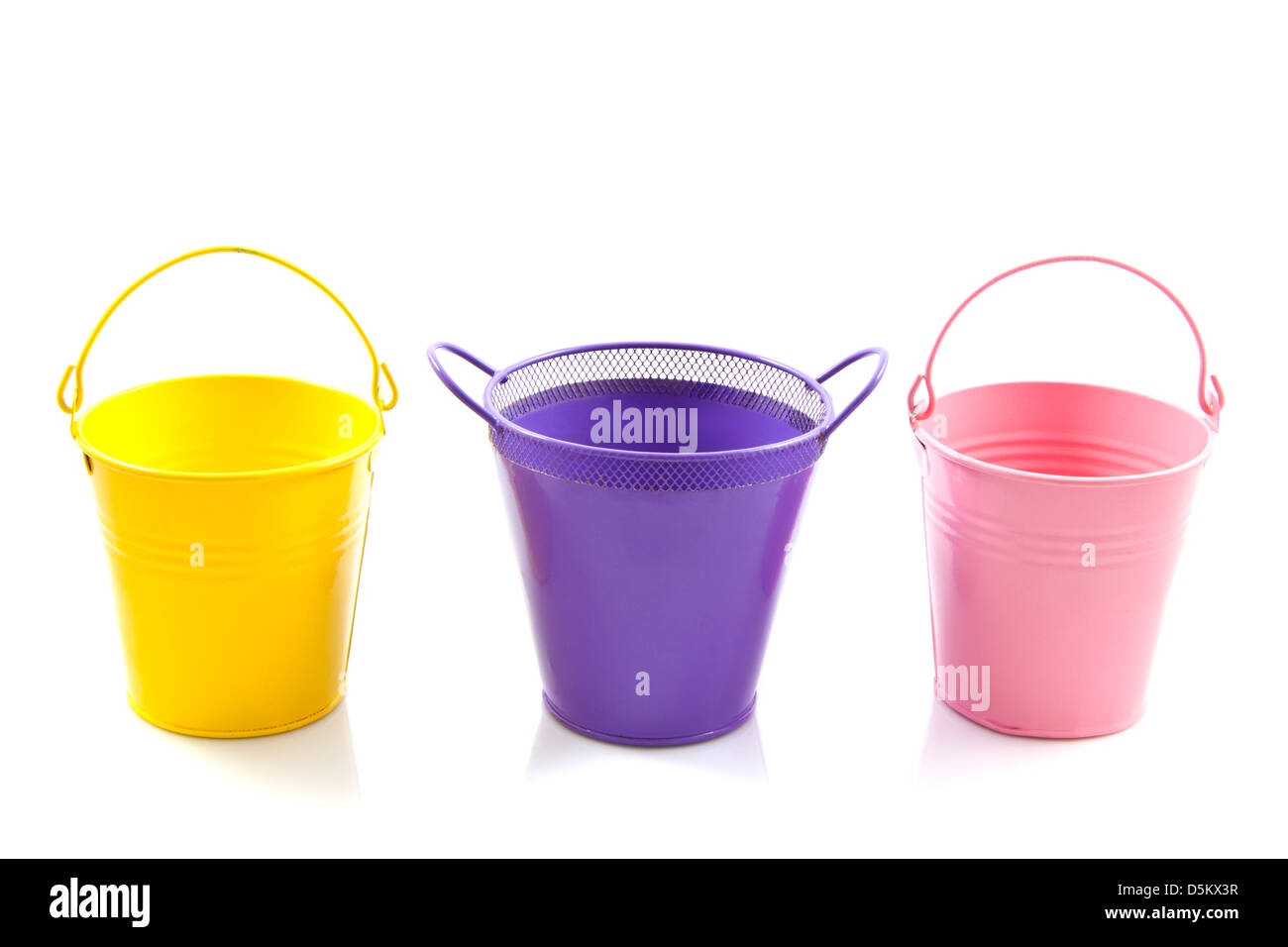 Three colorful buckets in a row isolated over white Stock Photo - Alamy