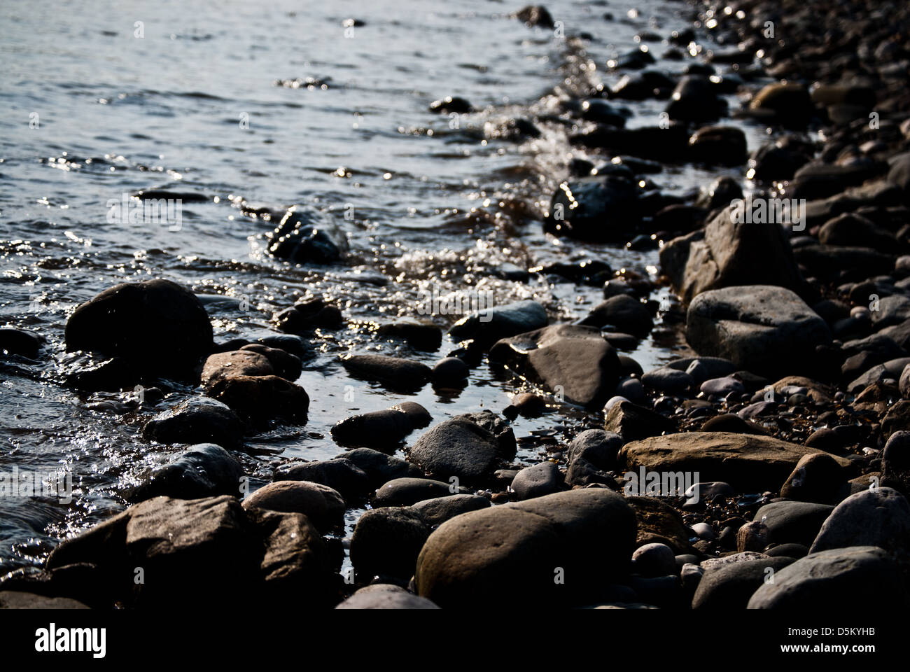 Water lapping onto rocks hi-res stock photography and images - Alamy