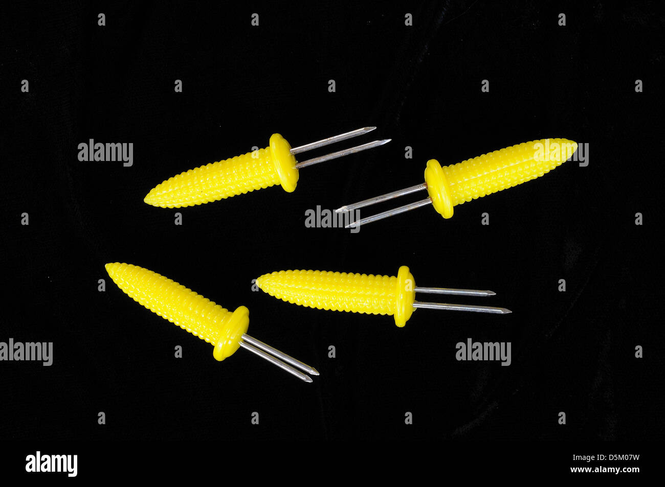 Yellow plastic corn on the cob skewers Stock Photo - Alamy