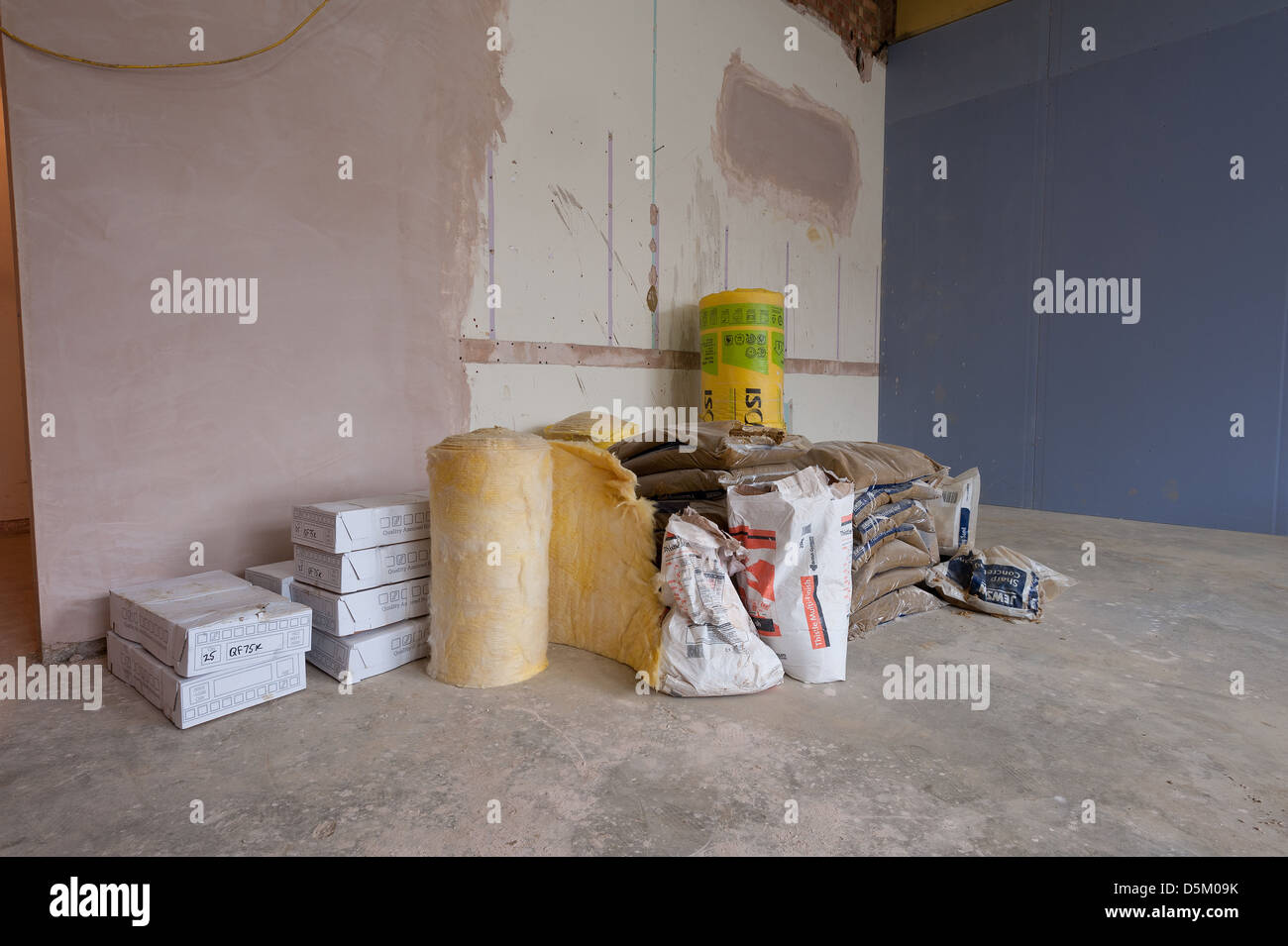 Bags of cement plaster rockwool insulation piled up inside a newly ...