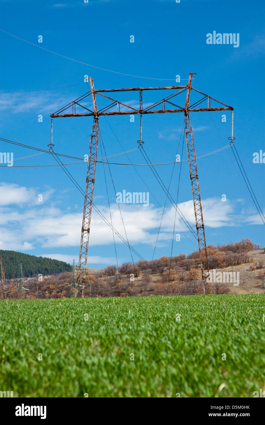 Steel lattice high voltage transmission tower in a green field under ...