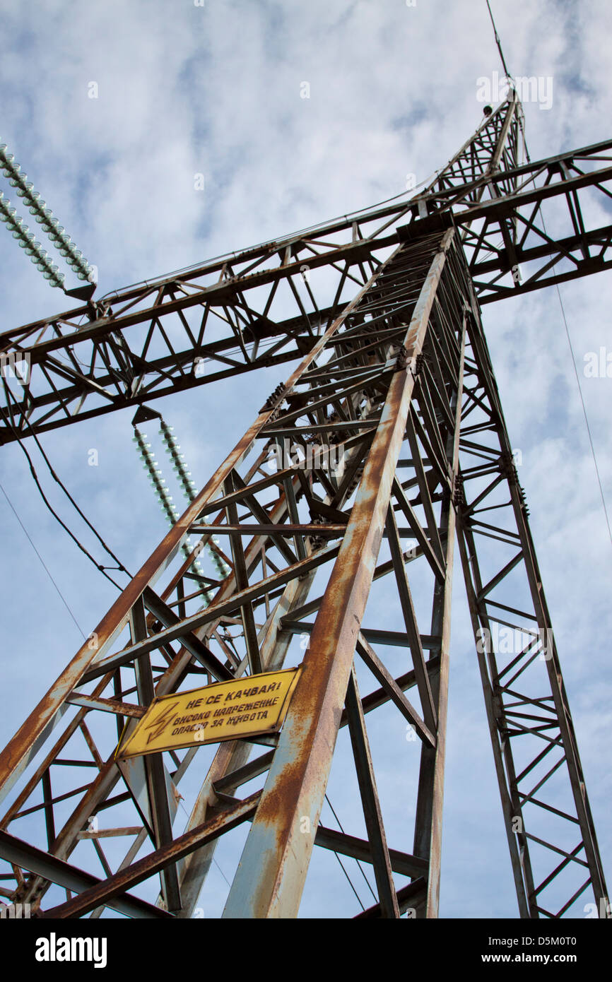 Steel lattice high voltage transmission tower with warning sign in ...
