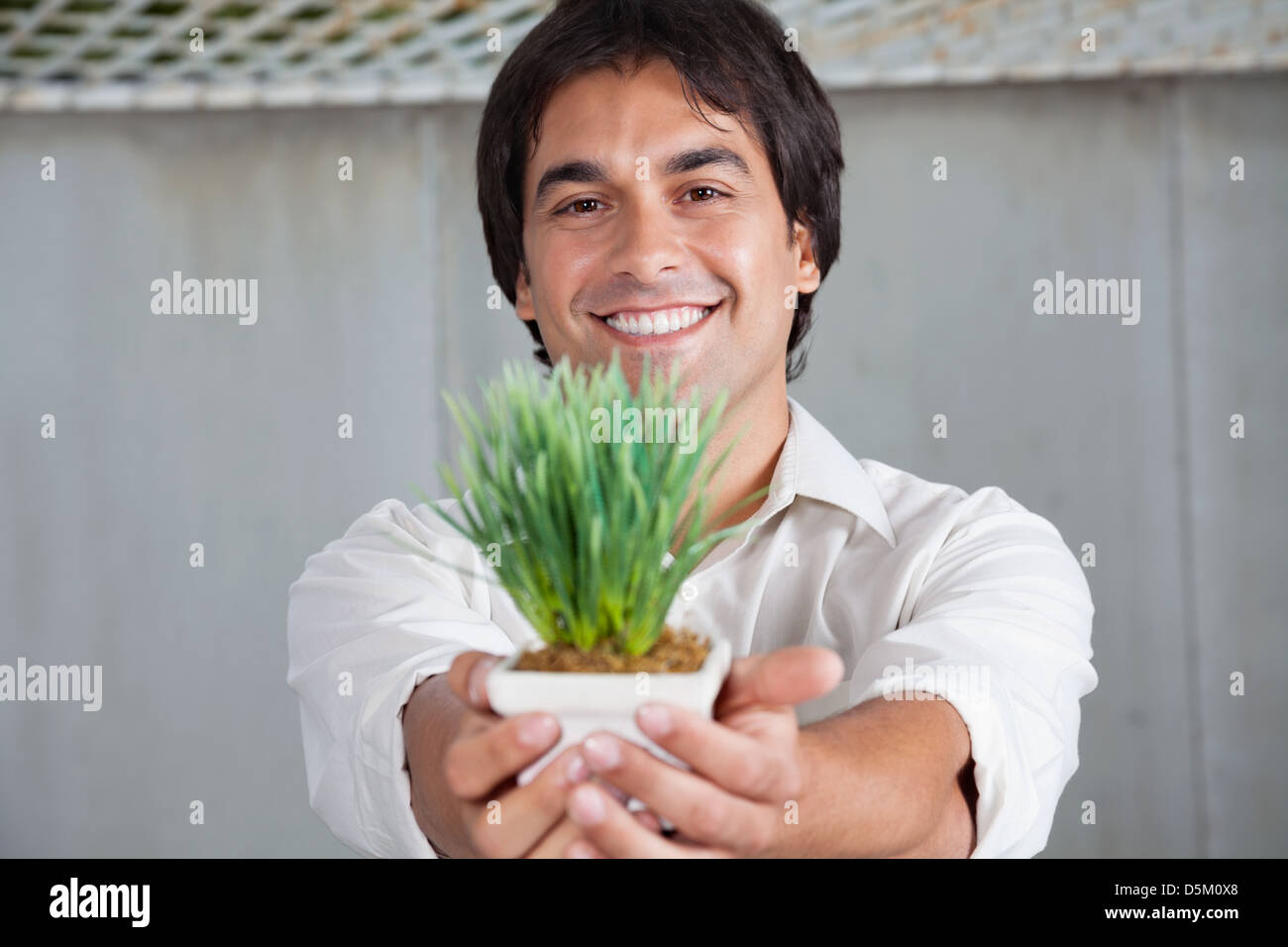 Happy Man Holding Plant Stock Photo - Alamy