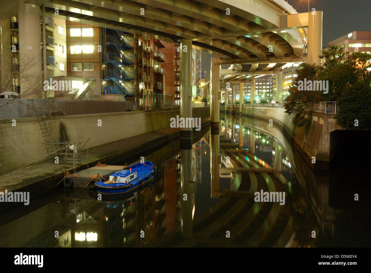 huge hanged-up highway going over waters of water channel with blue ...
