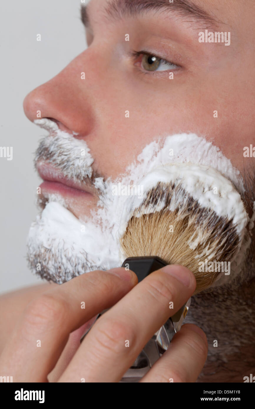 young man apply shaving cream on the face Stock Photo - Alamy