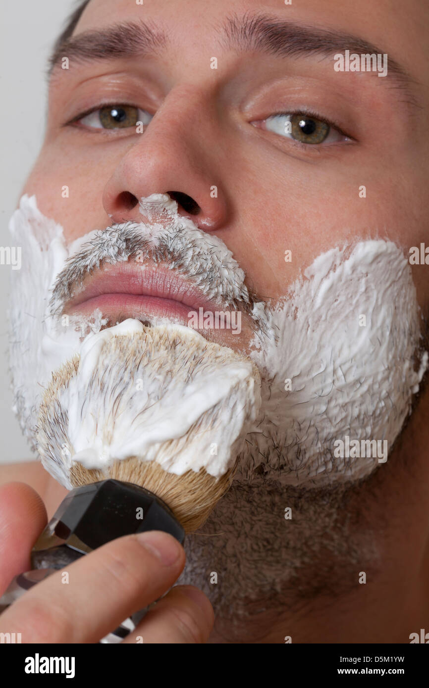 young man apply shaving cream on the face Stock Photo - Alamy