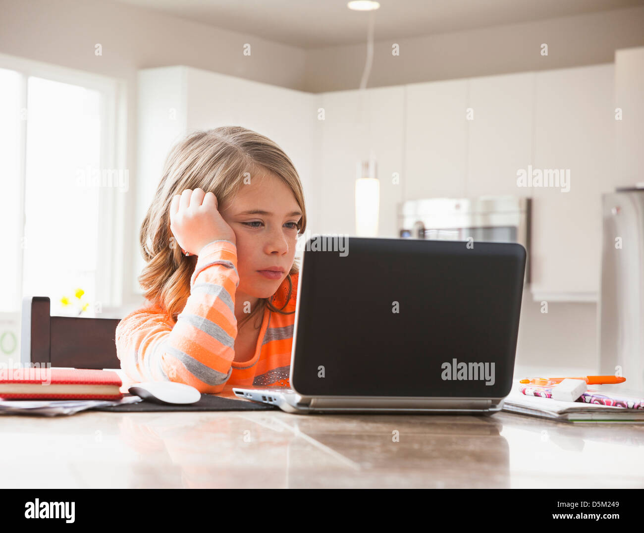 Girl doing homework using laptop hi-res stock photography and images ...