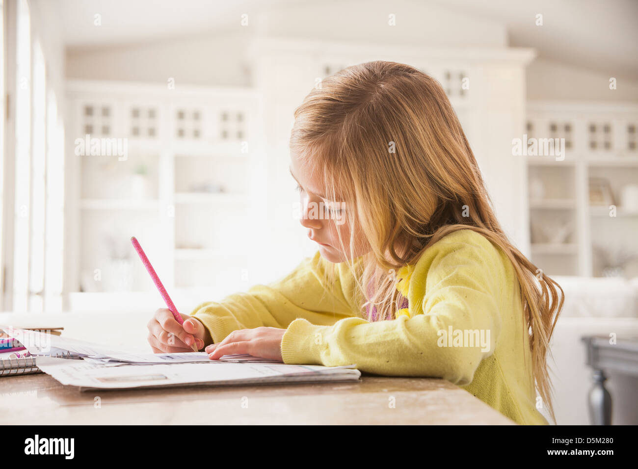 Girl (6-7) doing homework Stock Photo - Alamy