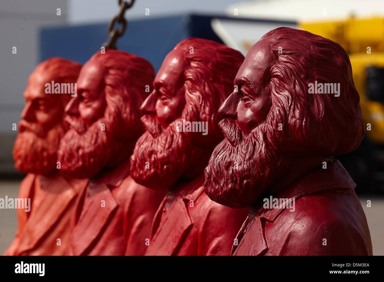 Four different colored Karl Marx figures by artist Ottmar Hoerl are ...
