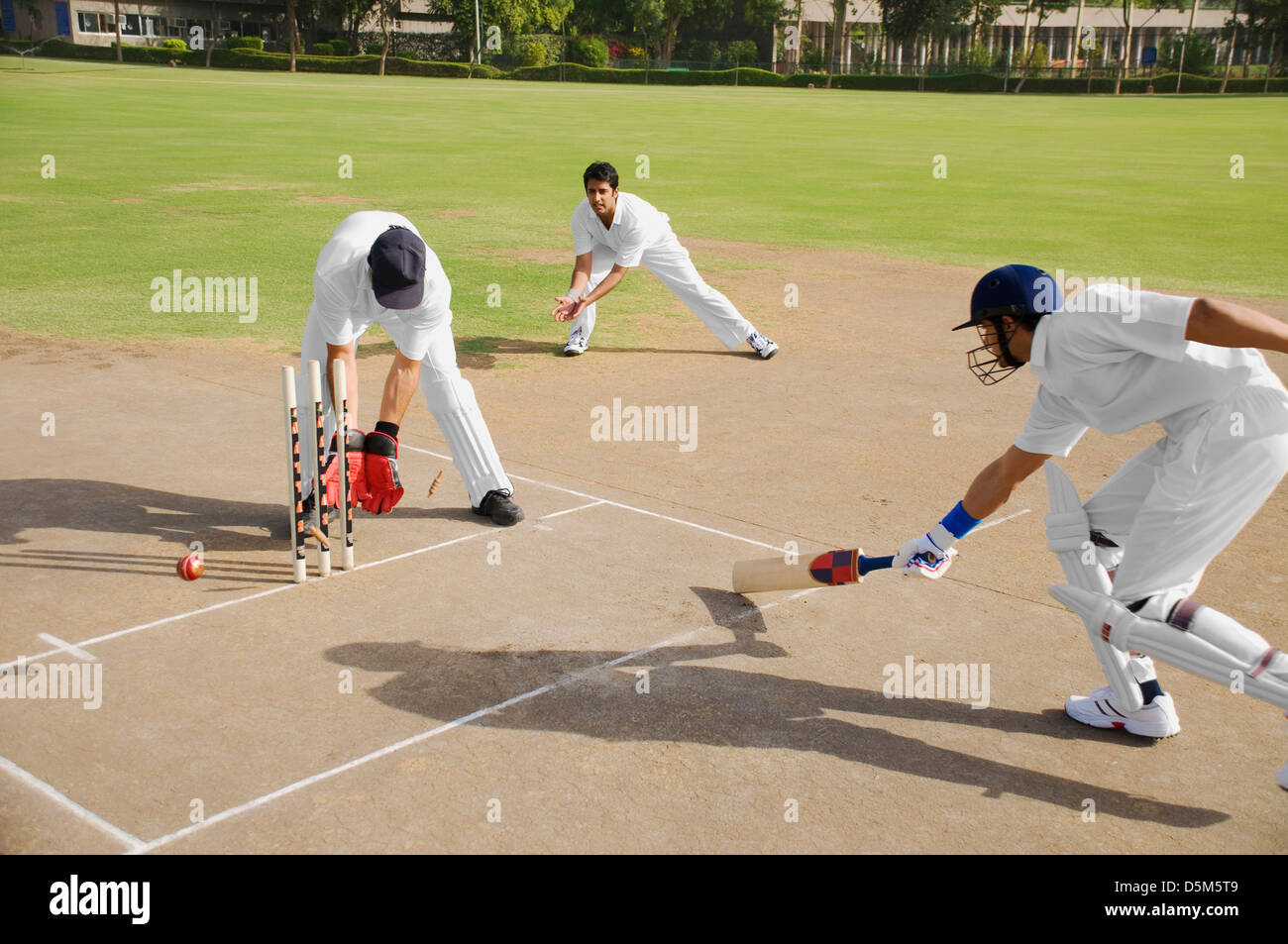 Batsman taking a run Stock Photo - Alamy