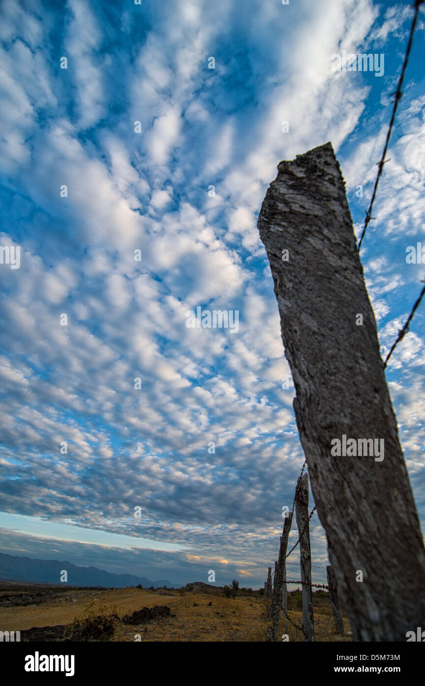 Fence post in a desert with a blue sky with dramatic clouds Stock Photo ...