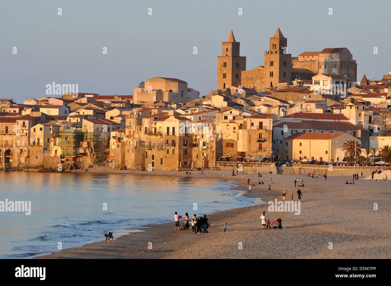 Beachgoers in the historic town of Cefalu on the coast of Sicily, Italy ...