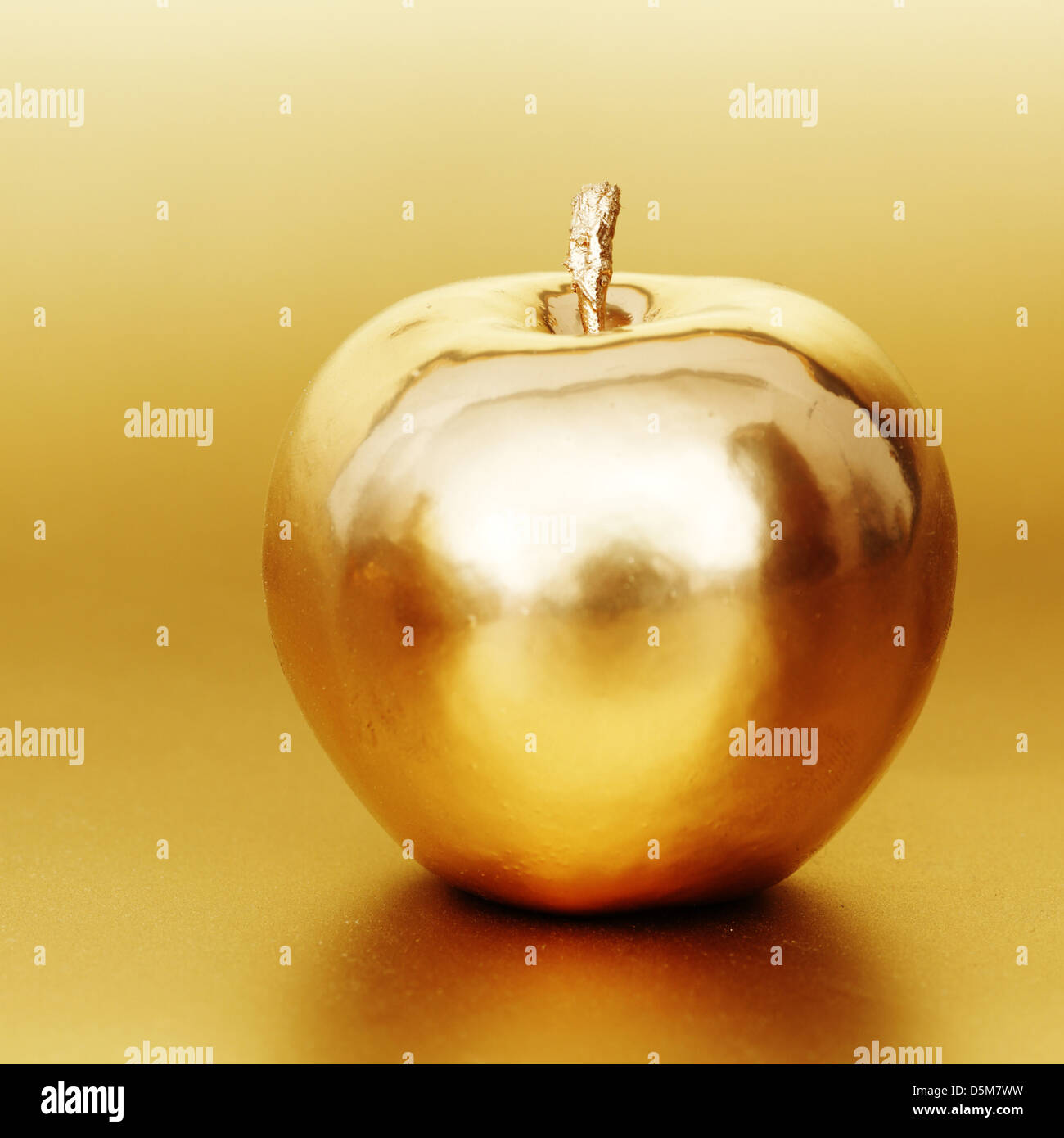 gold apple on gold background Stock Photo - Alamy