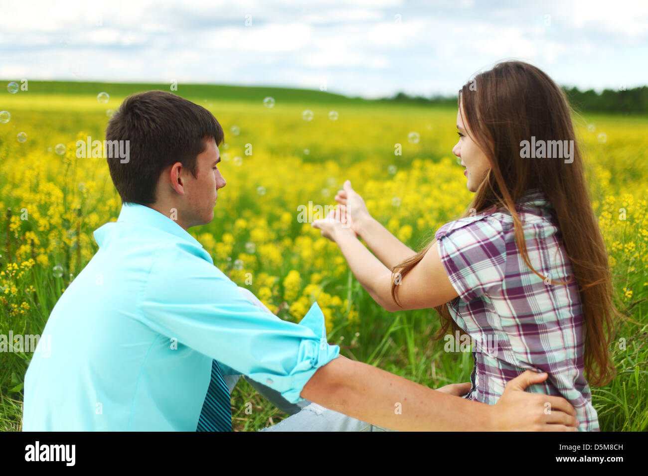 lovers hug on yellow flower field Stock Photo - Alamy