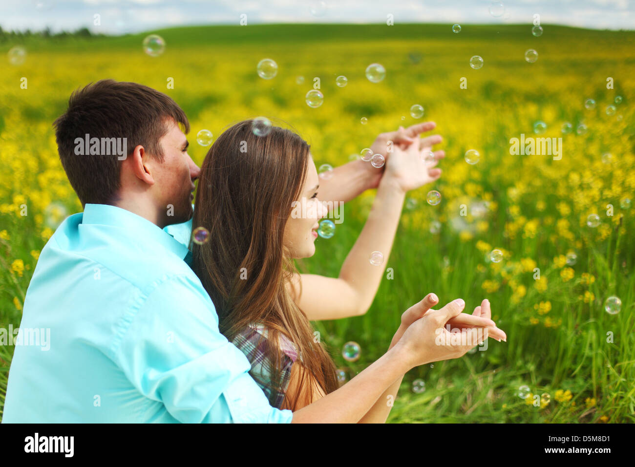 lovers hug on yellow flower field Stock Photo - Alamy