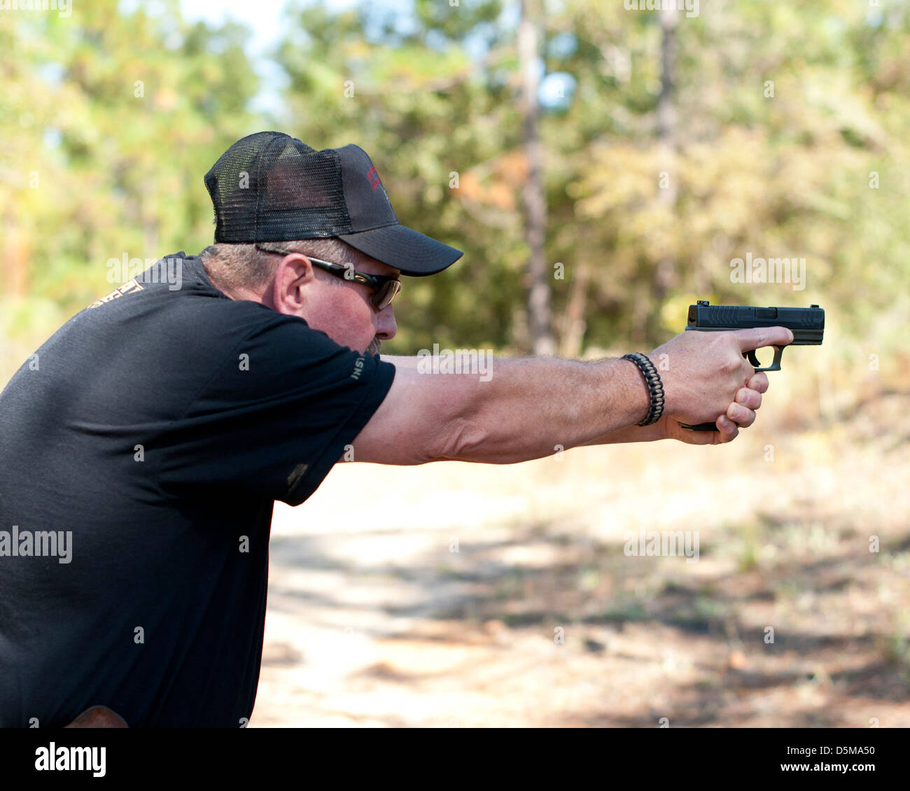 Man shooting a pistol Stock Photo - Alamy