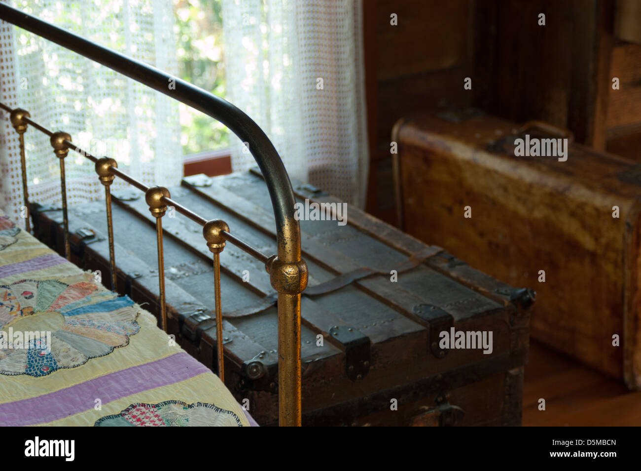 Interior bedroom in an historic farm home, with a brass bed, antique ...