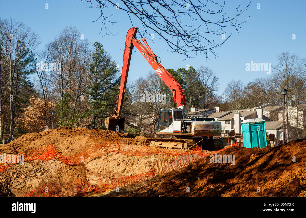 Heavy orange construction equipment on a residential site Stock Photo ...