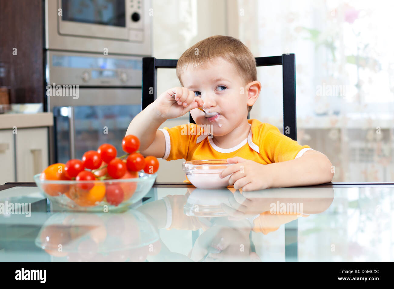 child boy eating healthy food in kitchen Stock Photo - Alamy