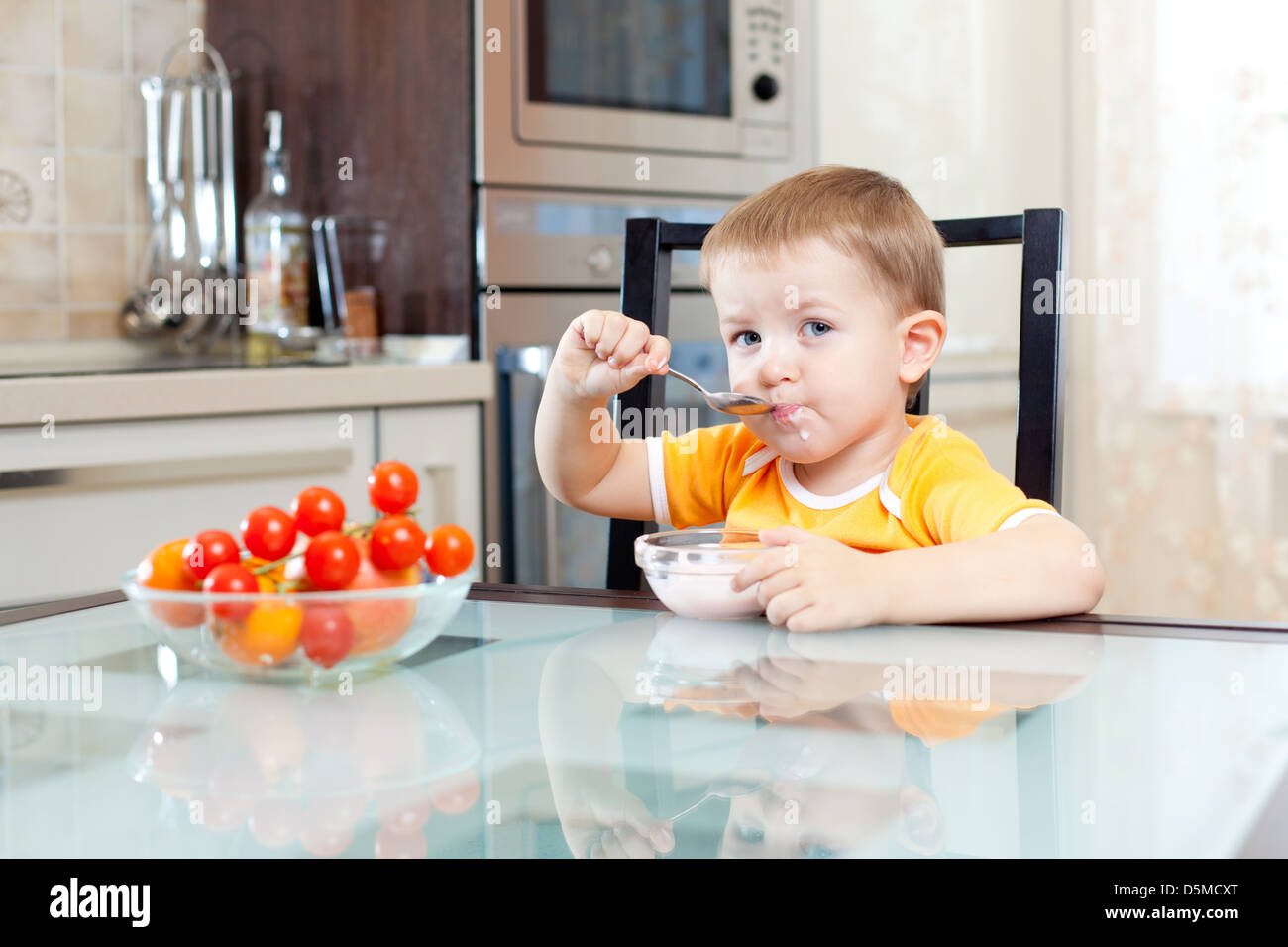 kid eating at home in kitchen Stock Photo - Alamy