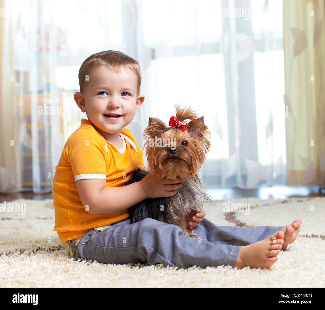 kid hugging puppy indoor Stock Photo - Alamy