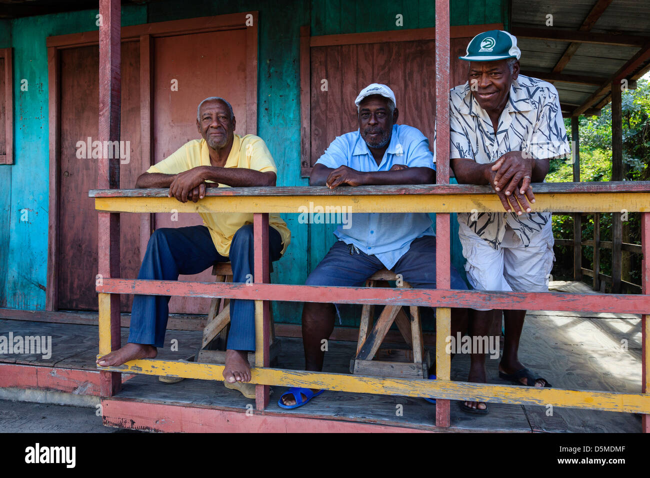Three local men from Vieux Fort town, St Lucia standing on the porch of ...