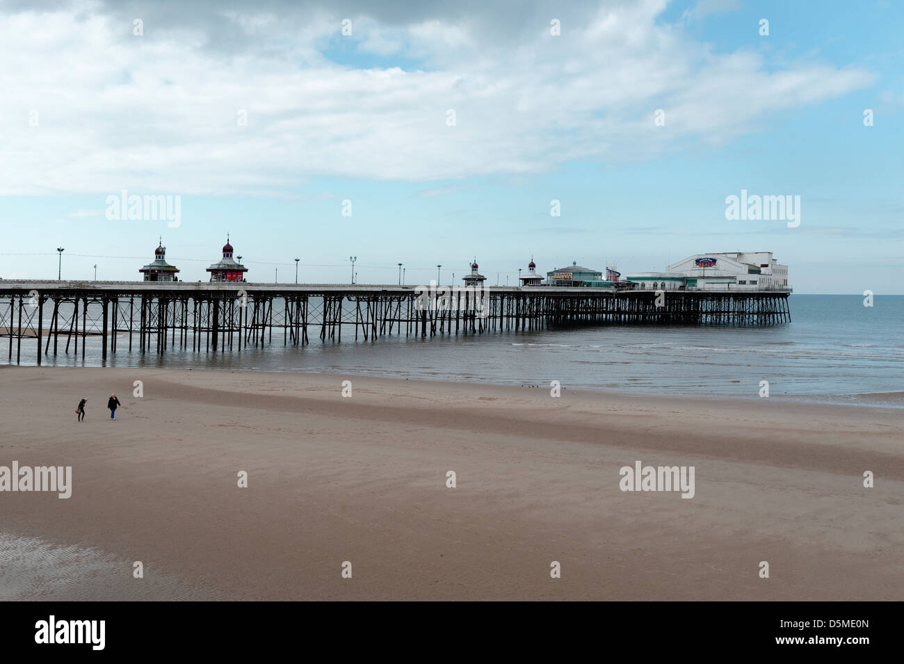 Two people walking on an empty beach by the North Pier, Blackpool Stock ...