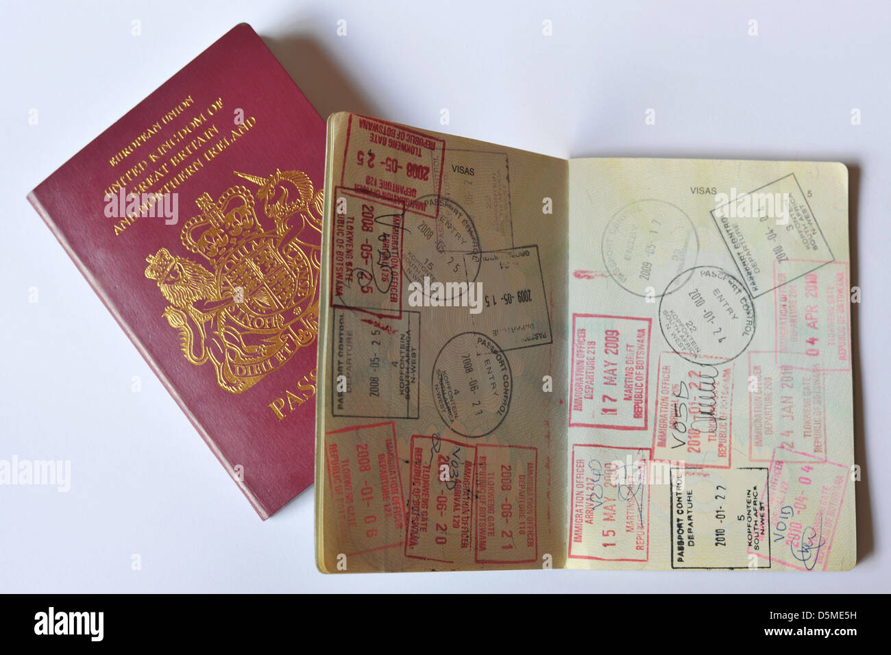 The Front Cover Of A British Passport And A Fully Stamped Visa Page