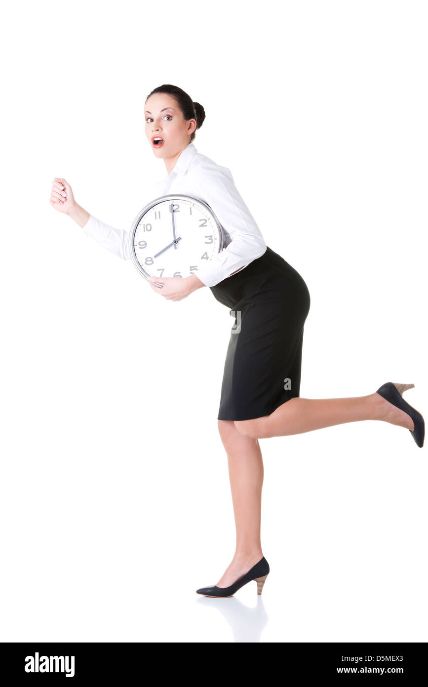 Business woman running late with clock under arm Stock Photo - Alamy