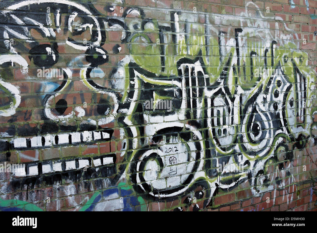 graffiti wall face nose eyes ear 500L bricks wall Stock Photo - Alamy
