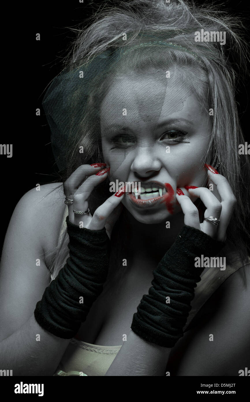 woman vampire with fangs on a black background Stock Photo - Alamy