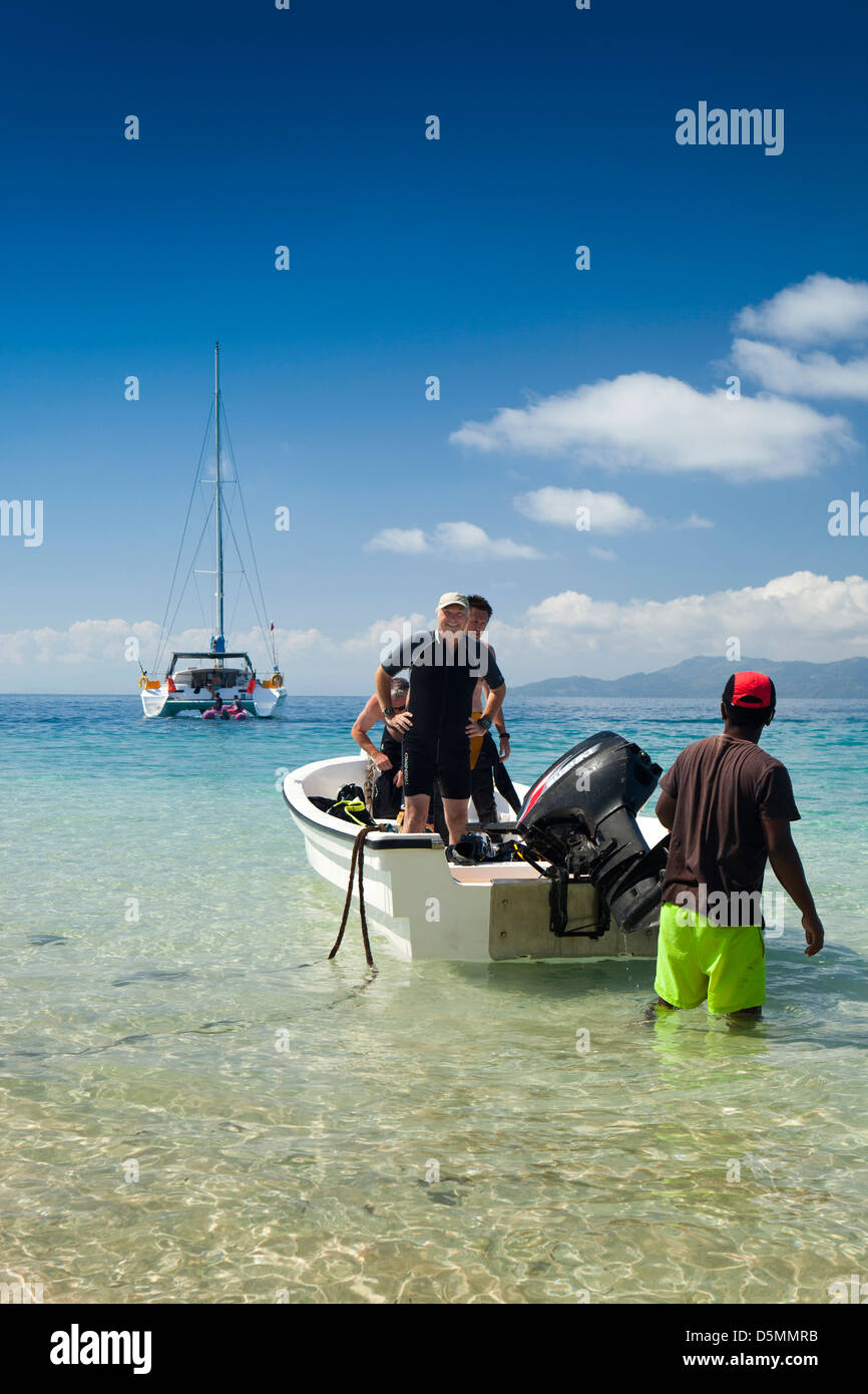 Madagascar, Nosy Be, Nosy Tanikely island scuba divers in boat arriving ...