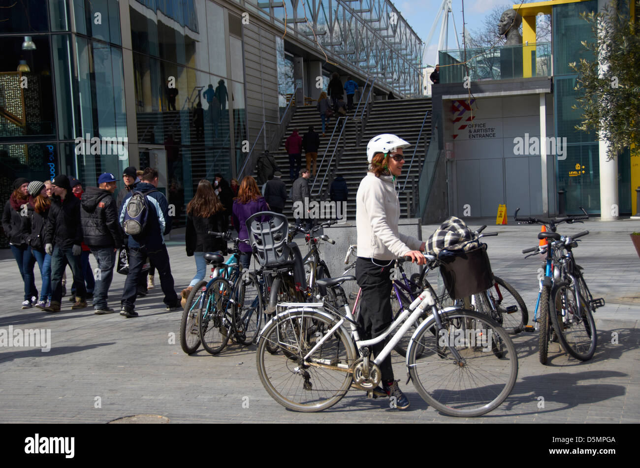 Woman pushing a bike at the Southbank London England Stock Photo - Alamy