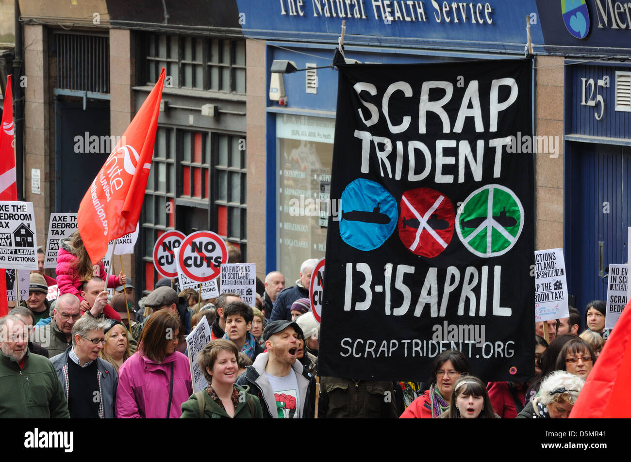 Political march in Glasgow. A large banner is held aloft with the ...