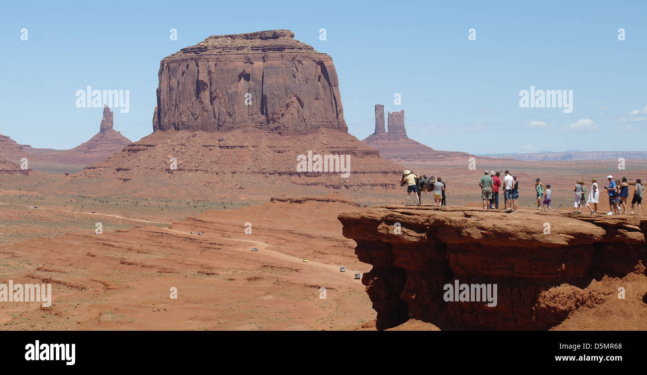Blue sky view, towards Merrick Butte, tourists walking towards cowboy ...