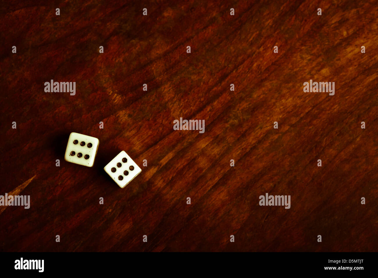 Two dice displaying six on a vintage wood plank Stock Photo - Alamy
