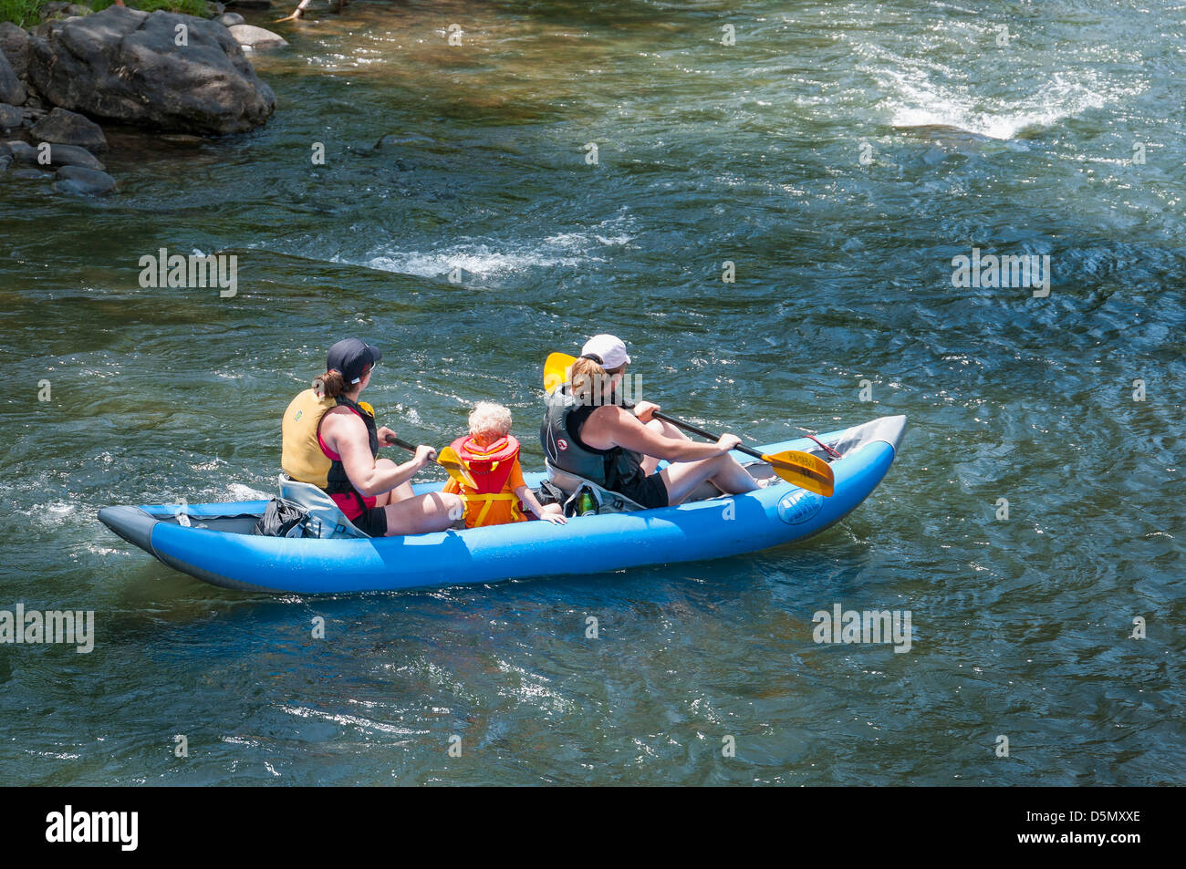 Two women and a child ride a ducky down the Animas River, Durango ...