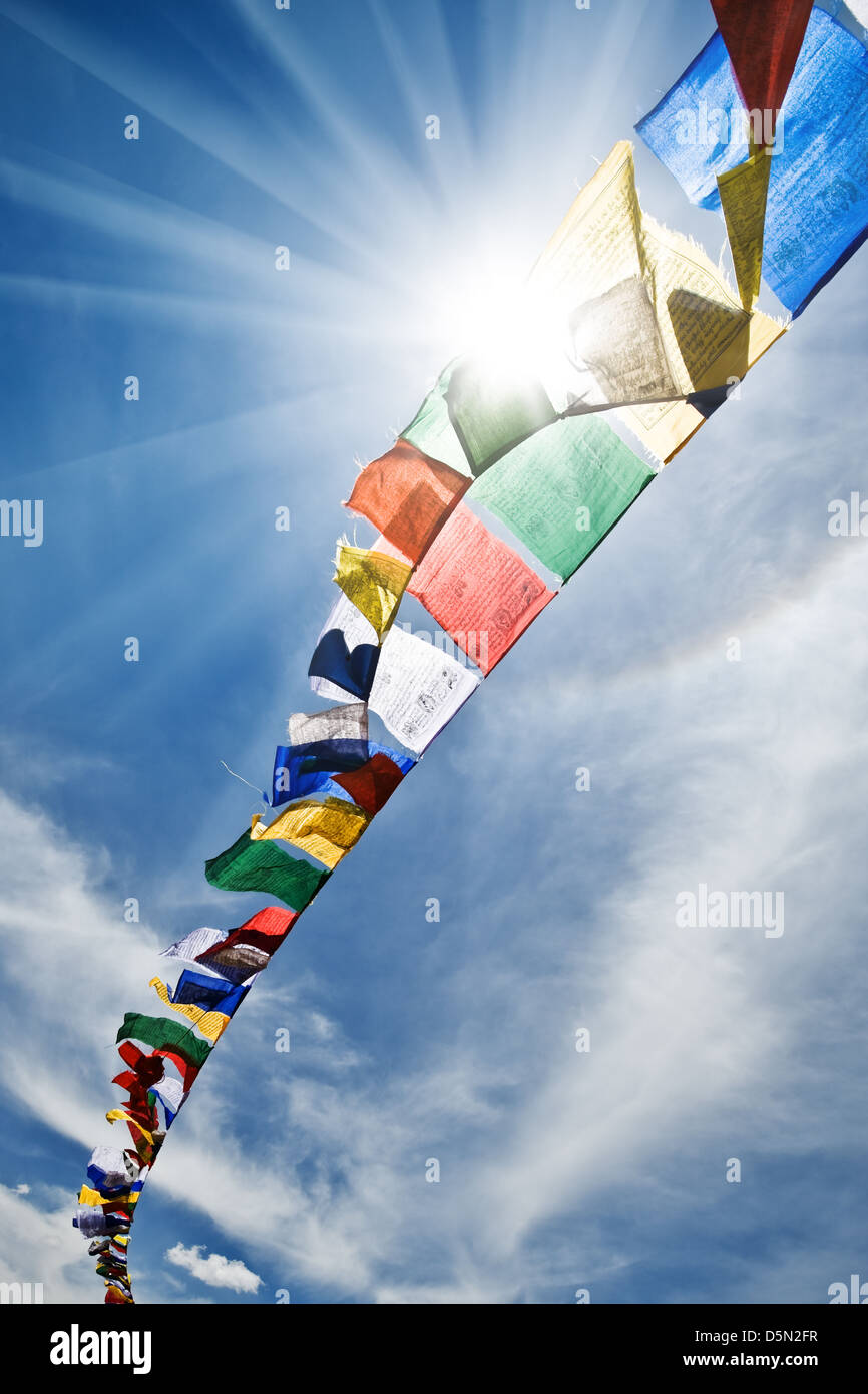 tibetan flags with mantra on sky background Stock Photo - Alamy